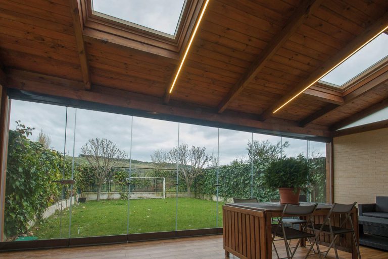 Porche acristalado con techo de madera, teja y velux | Proyectos Echarri